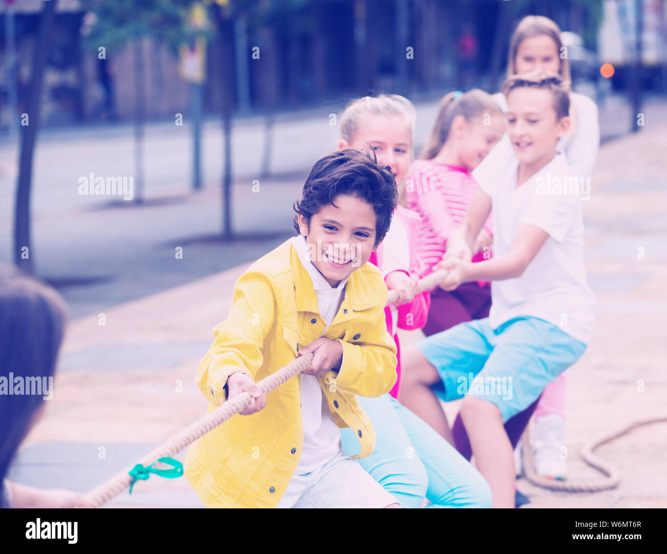 Children are pulling rope in the park Stock Photo - Alamy