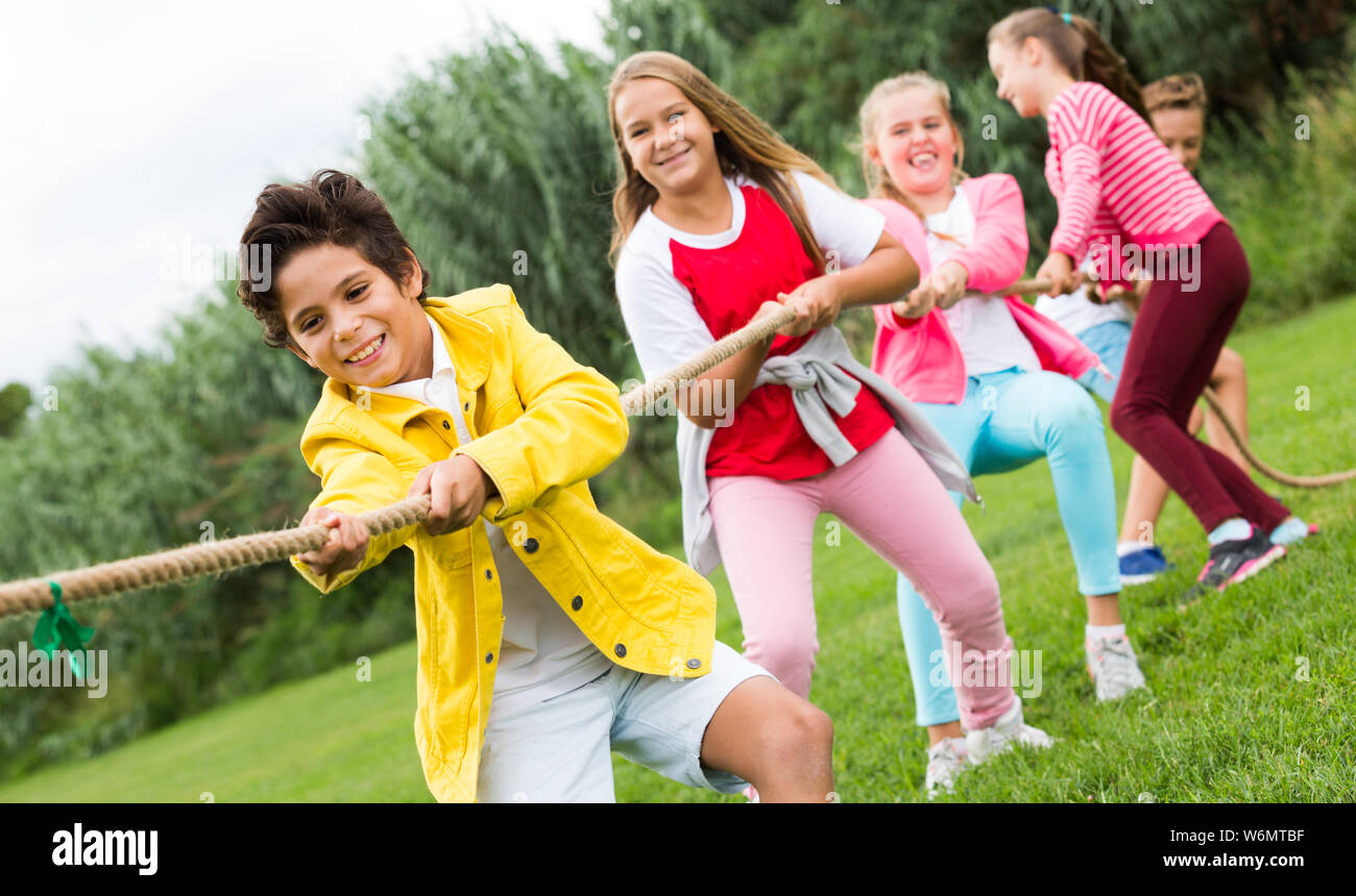 Children are pulling rope in the park Stock Photo - Alamy