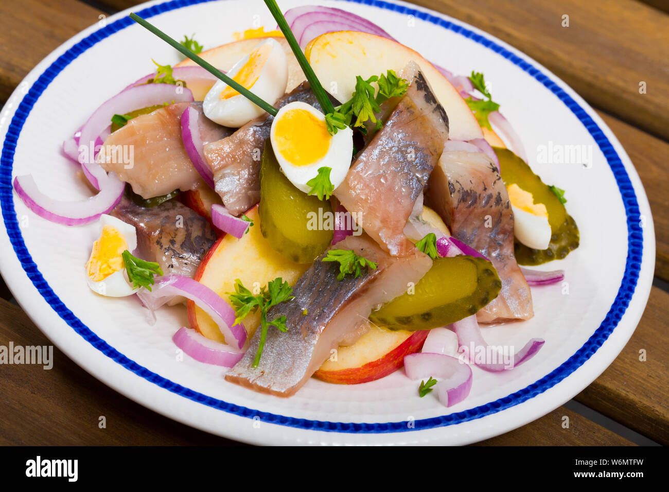 Traditional Norwegian salad of marinated herring fillet with fresh ...