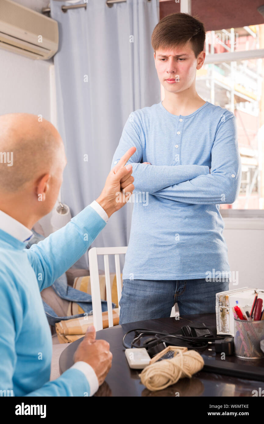 Portrait of troubled teenage boy and his father scolding him Stock ...