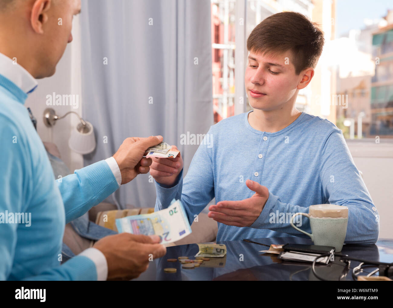 Adult son asking father for money hi-res stock photography and images ...
