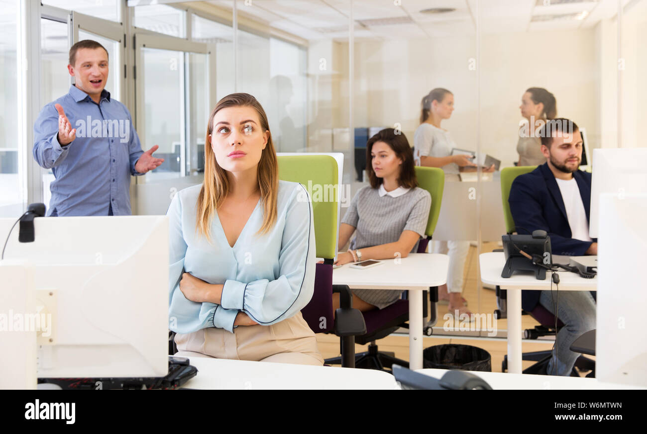 Irritated young boss scolding adult female subordinate pointing out ...