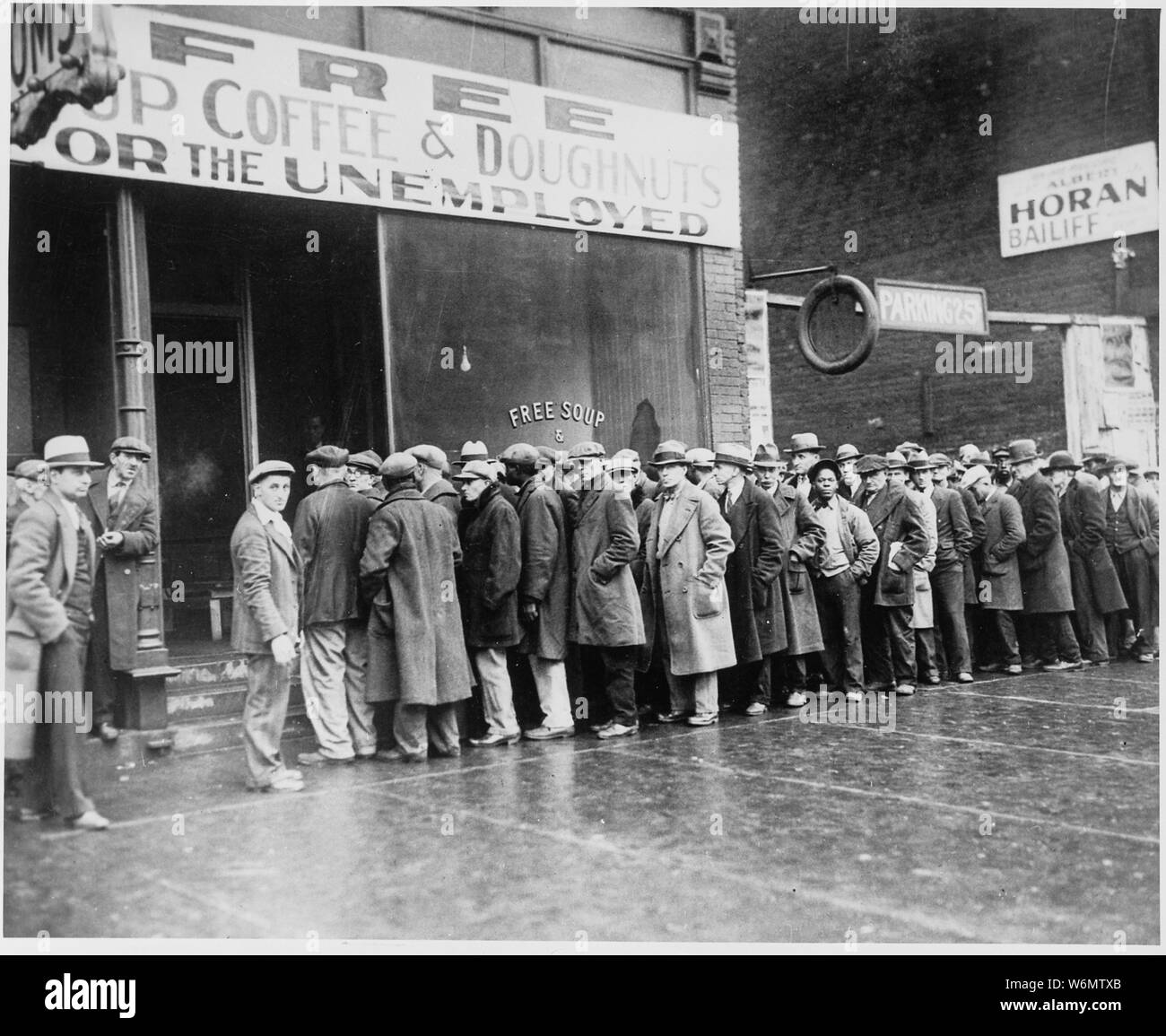 Unemployed men queued outside a depression soup kitchen opened in ...