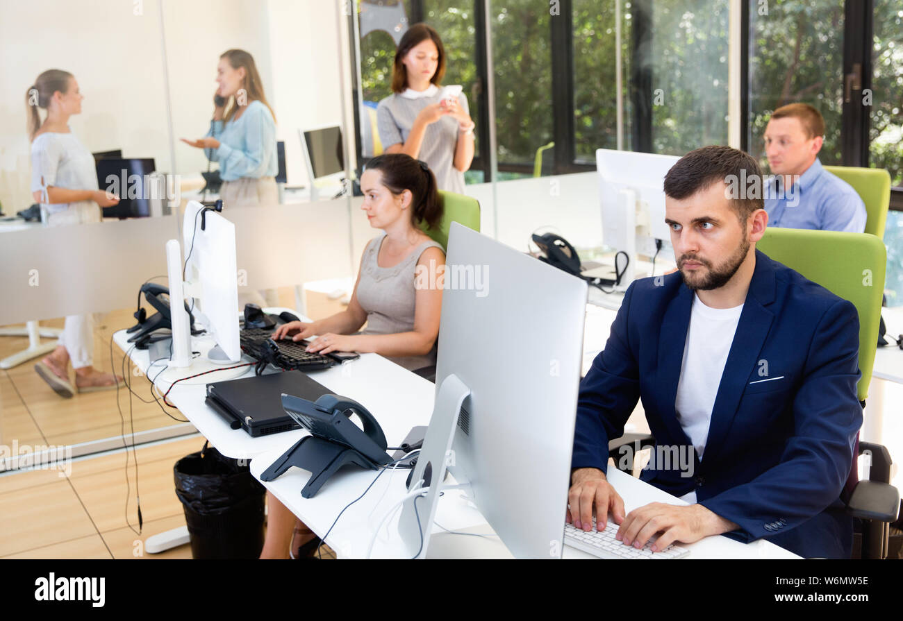 Group of successful diligent smiling business people during daily work ...