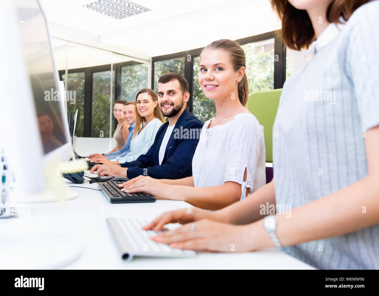 Side view of diligent cheerful smiling successful business people ...