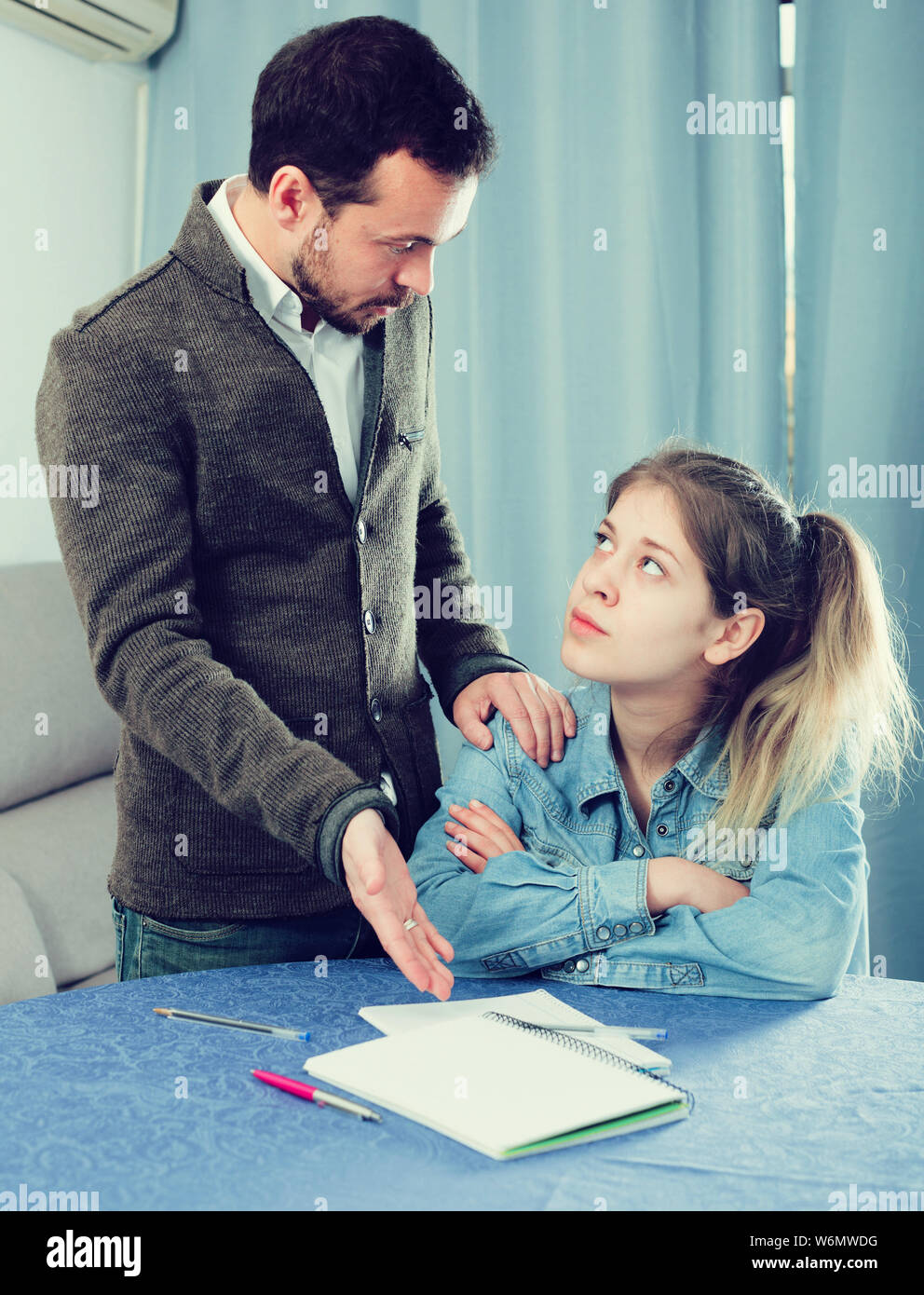 Young father explaining homework to his daughter at home Stock Photo ...
