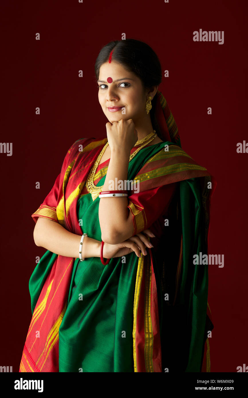 Bengali woman standing with her hand on chin Stock Photo - Alamy