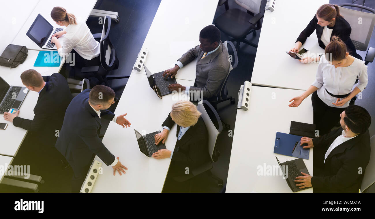 Top view of successful managers engaged in business activities in busy ...