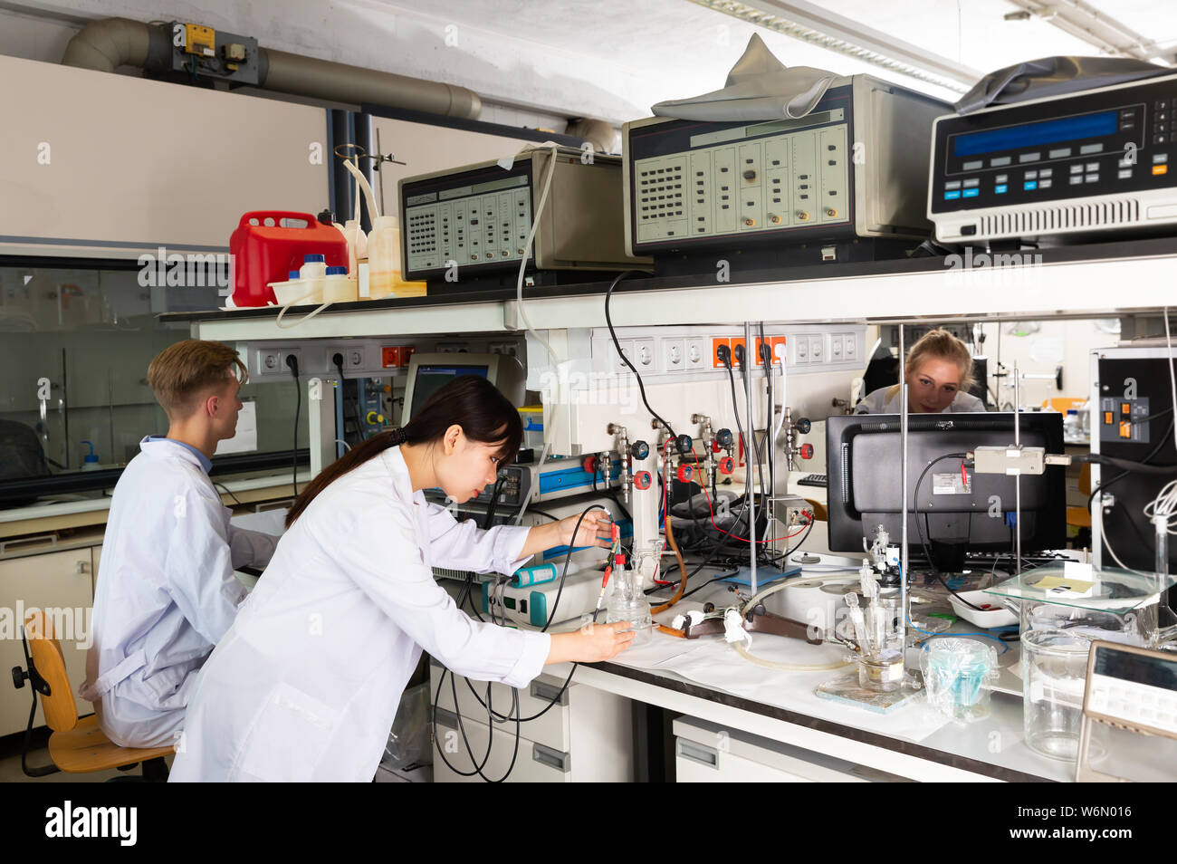 View of modern university research laboratory with multiracial group of ...
