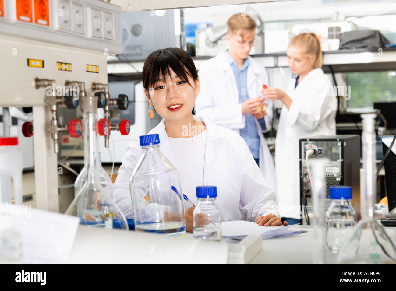 Young glad friendly smiling Chinese female student posing near ...
