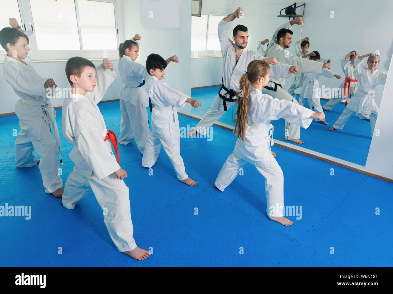 Children attempting to coach and trying a new moves during karate class ...