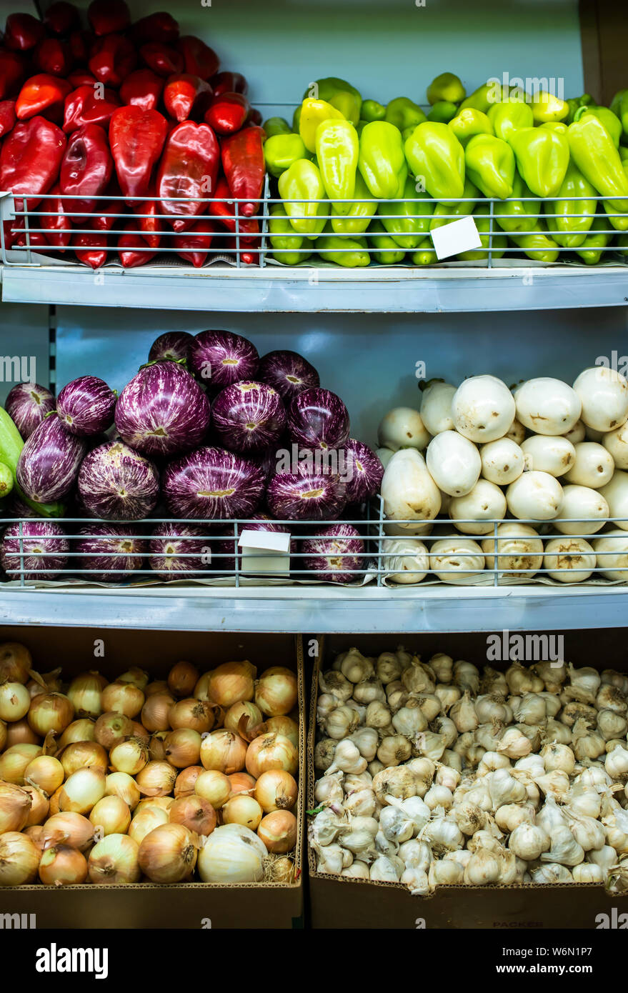 Vegetable on shelf in the market. Peppers, onion, eggplants and garlic ...