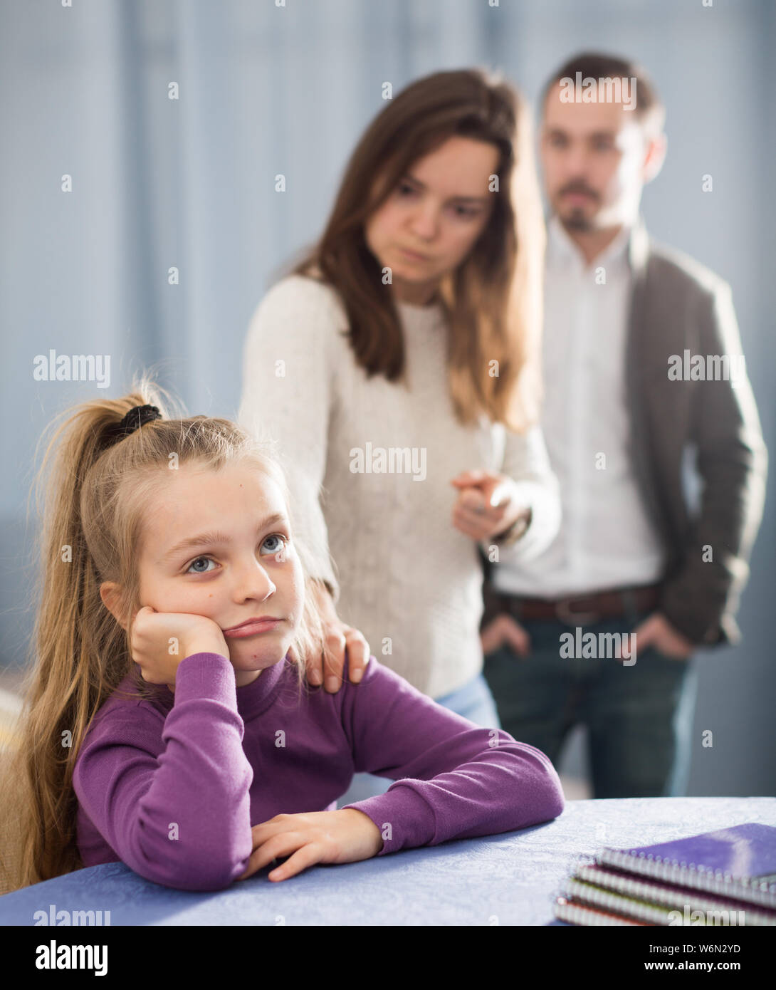 Father and mother telling off their daughter for disobedience Stock ...