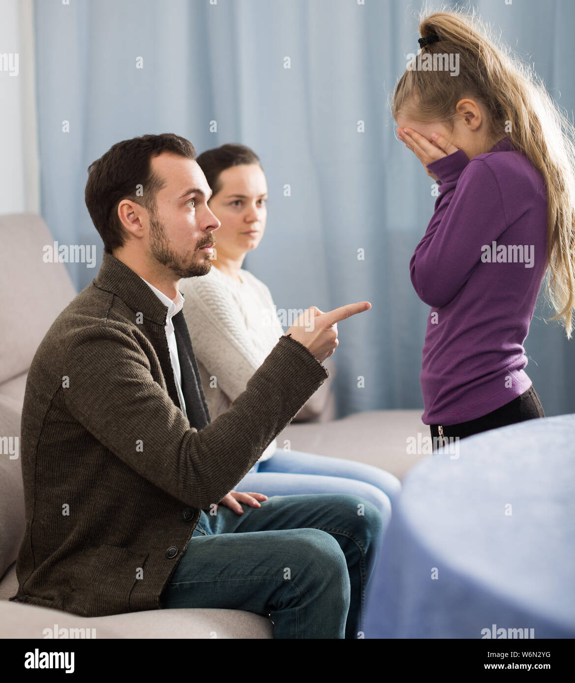 Young parents lecturing their daughter for bad behavior at home Stock ...