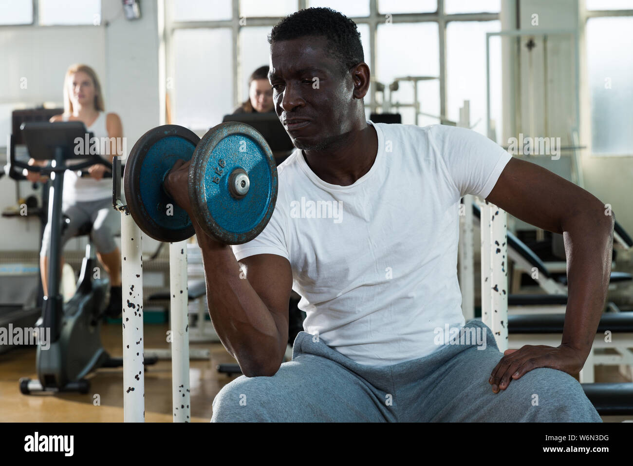 Portrait of African man doing exercises with dumbell at gym Stock Photo ...
