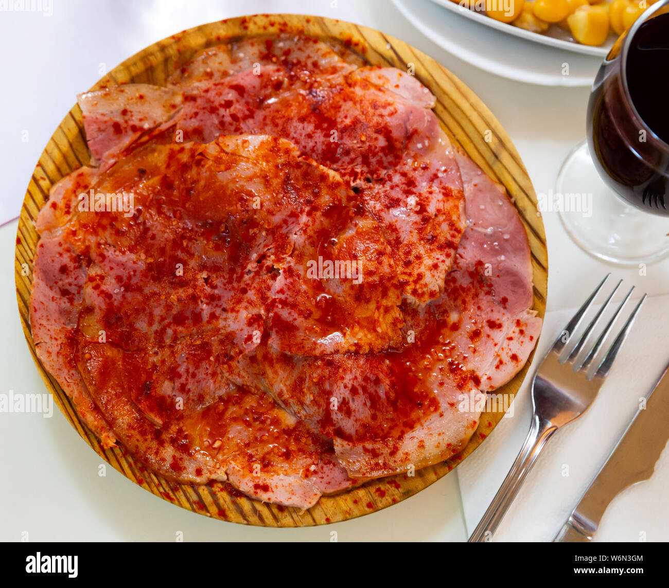 Slices of lacon galician boiled pig ham served at plate Stock Photo - Alamy