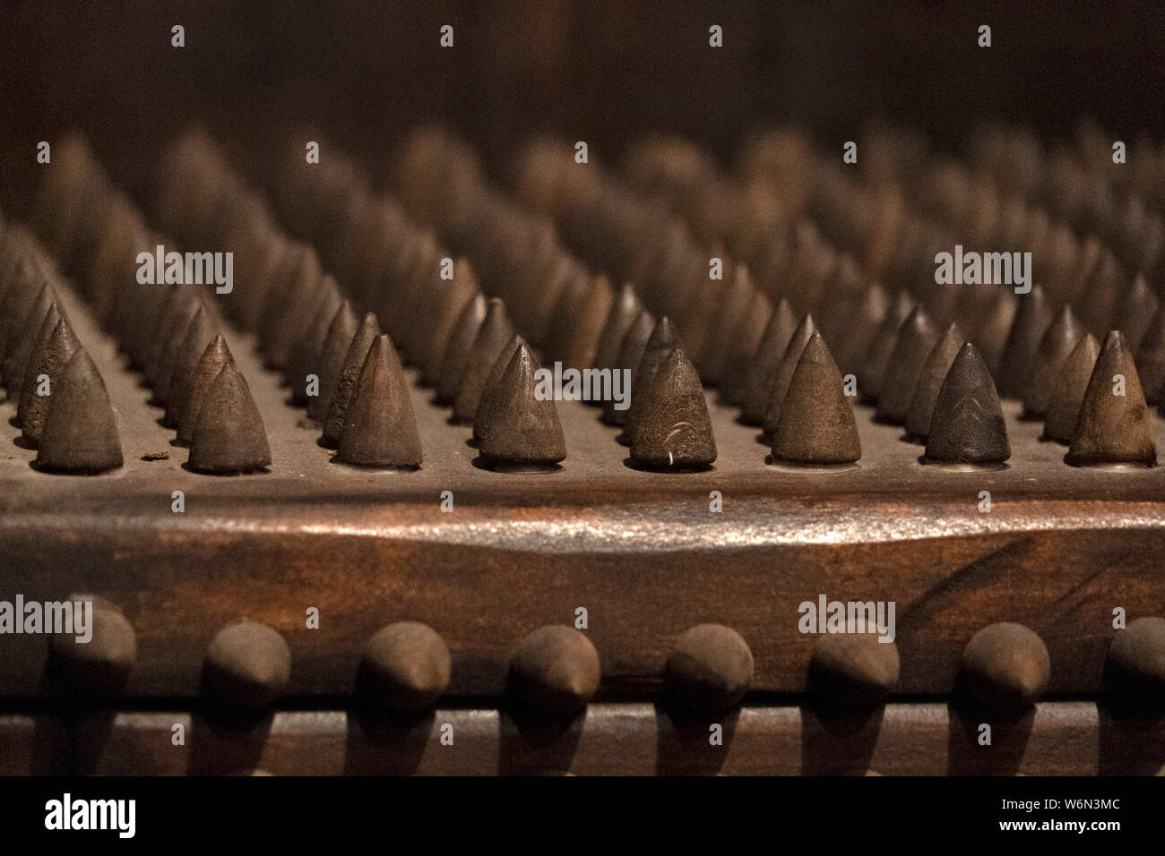Torture iron spikes medieval chair detail Stock Photo - Alamy