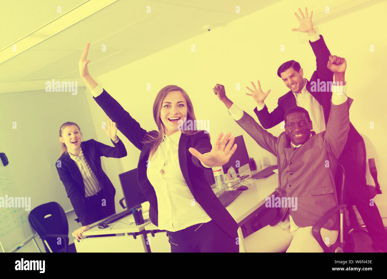 Satisfied multinational business team expressing satisfaction with ...