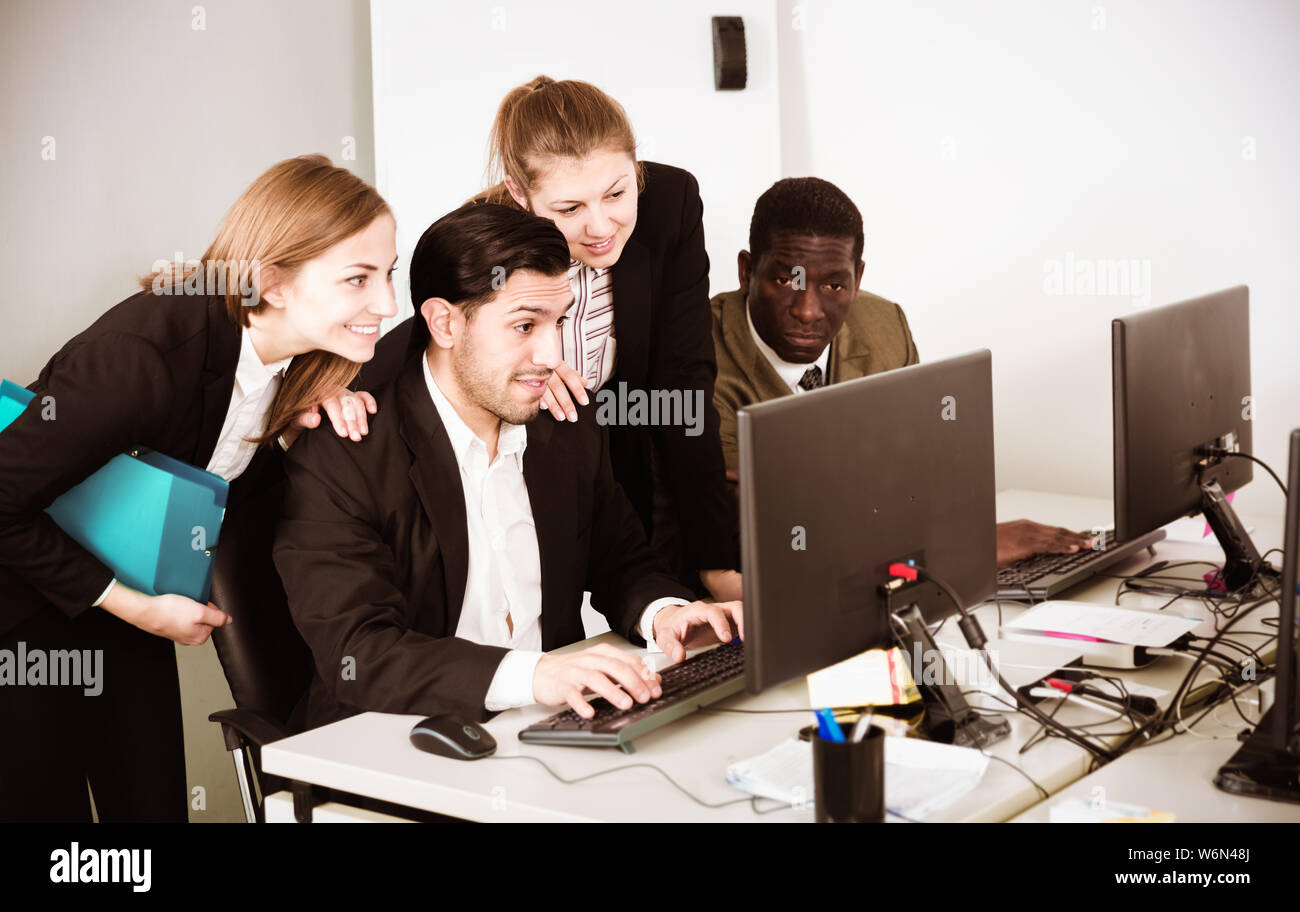 Team of managers developing strategy together in modern office with ...