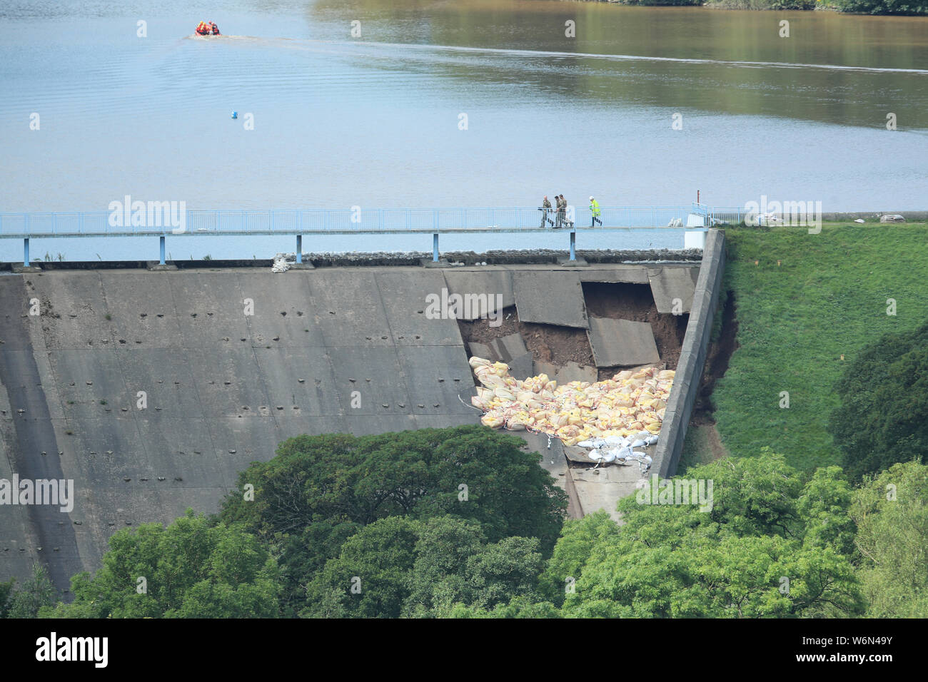 Members of the armed services walk across the dam at Toddbrook ...