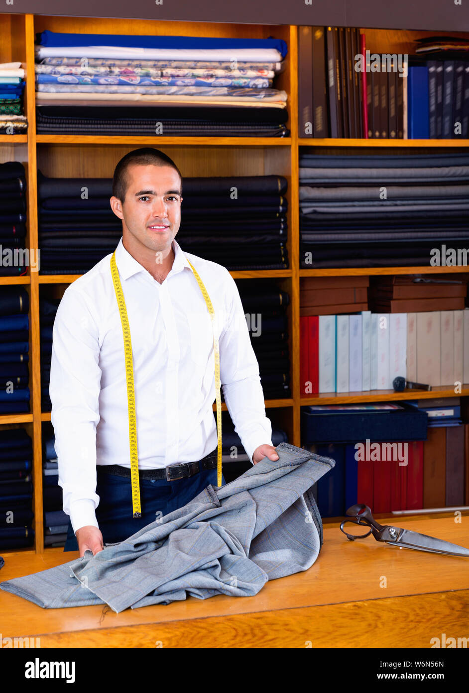 Smiling cheerful positive successful male administrator of clothing ...