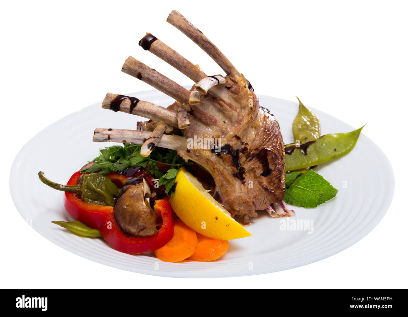 Roasted rack of mutton served with baked vegetables, mushrooms, fresh ...