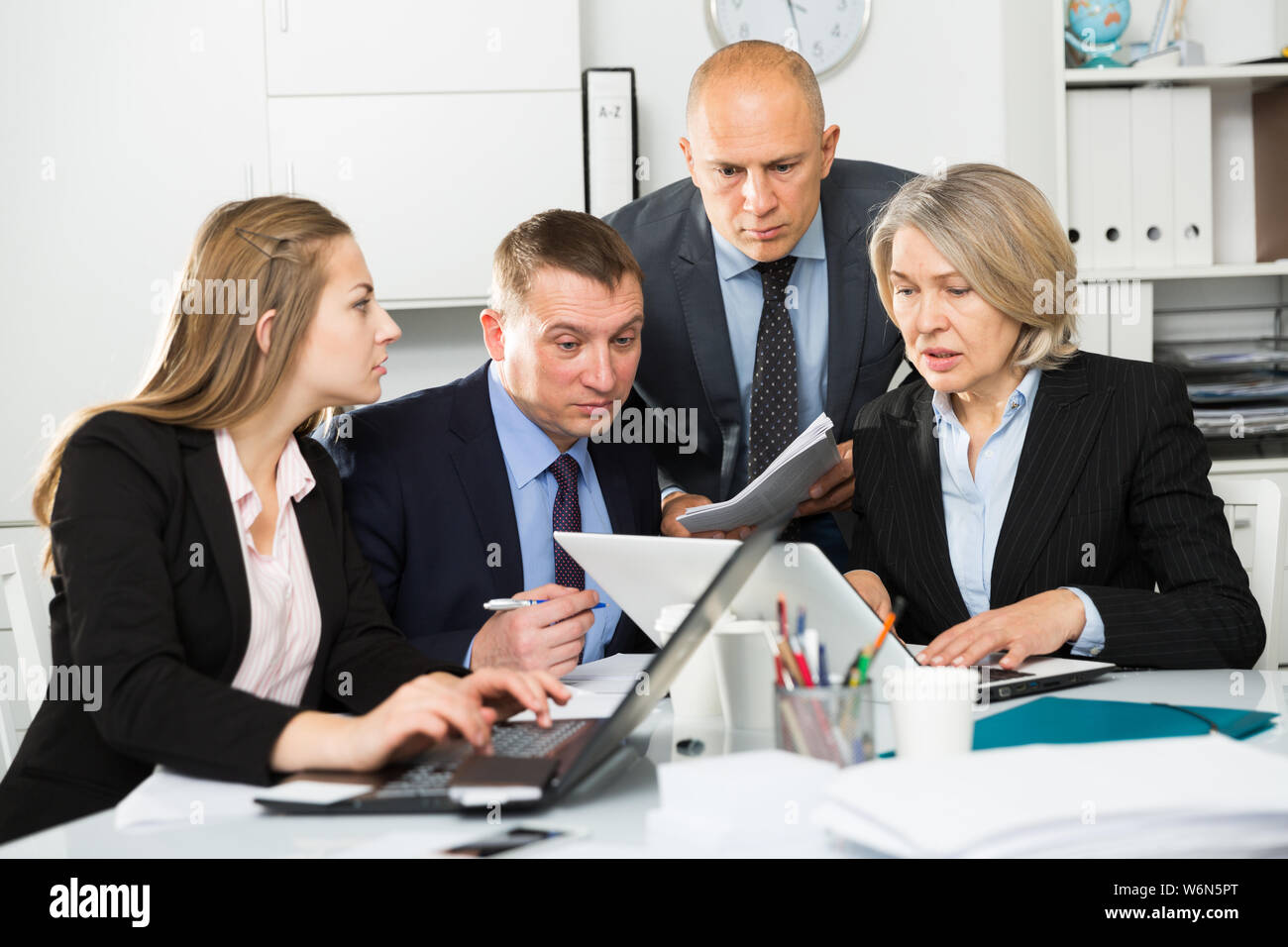 Concerned business people working and discussing problems together in ...