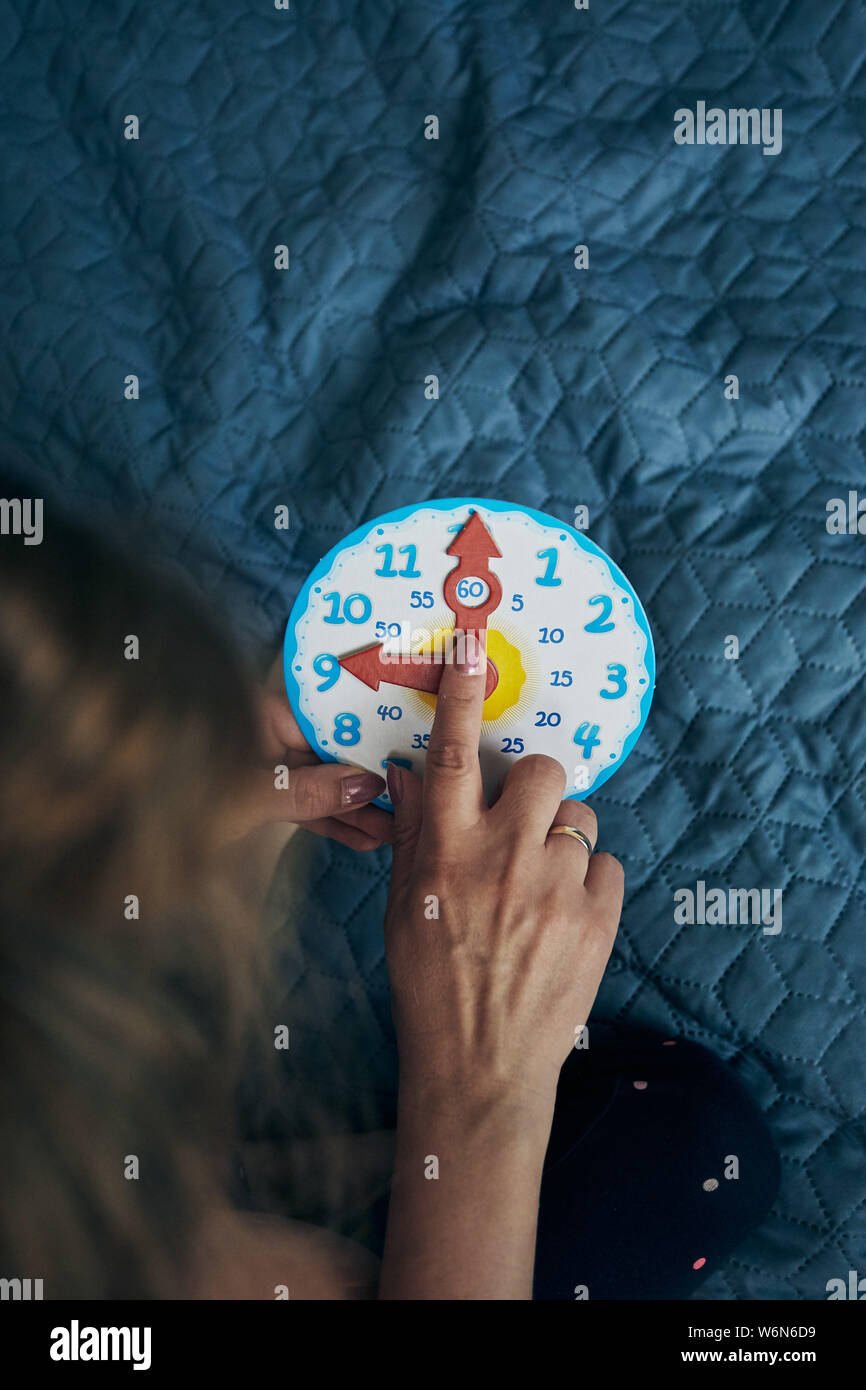 Kids learning how to tell time from clock and set the hands in the ...