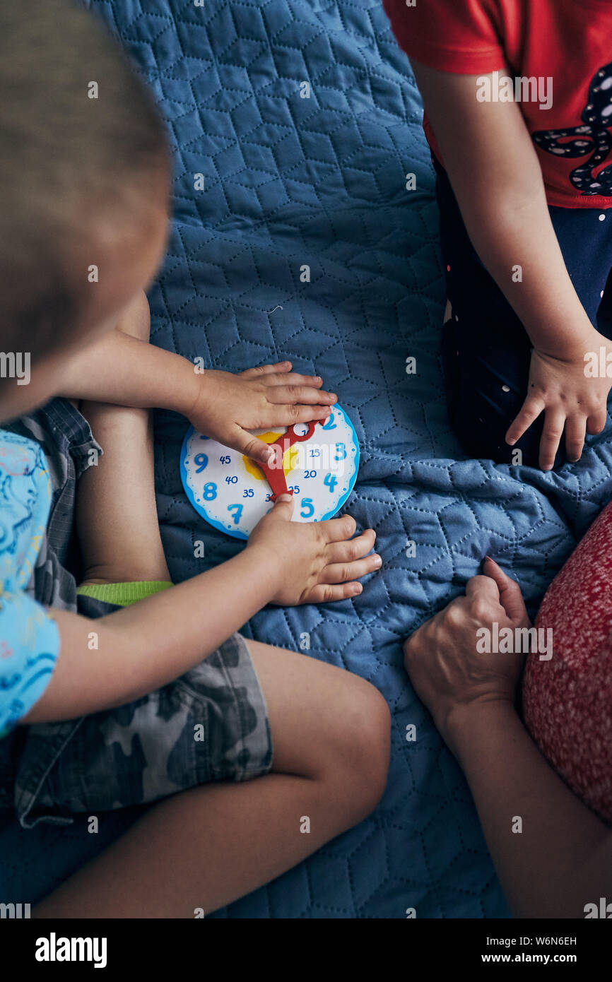 Kids learning how to tell time from clock and set the hands in the ...
