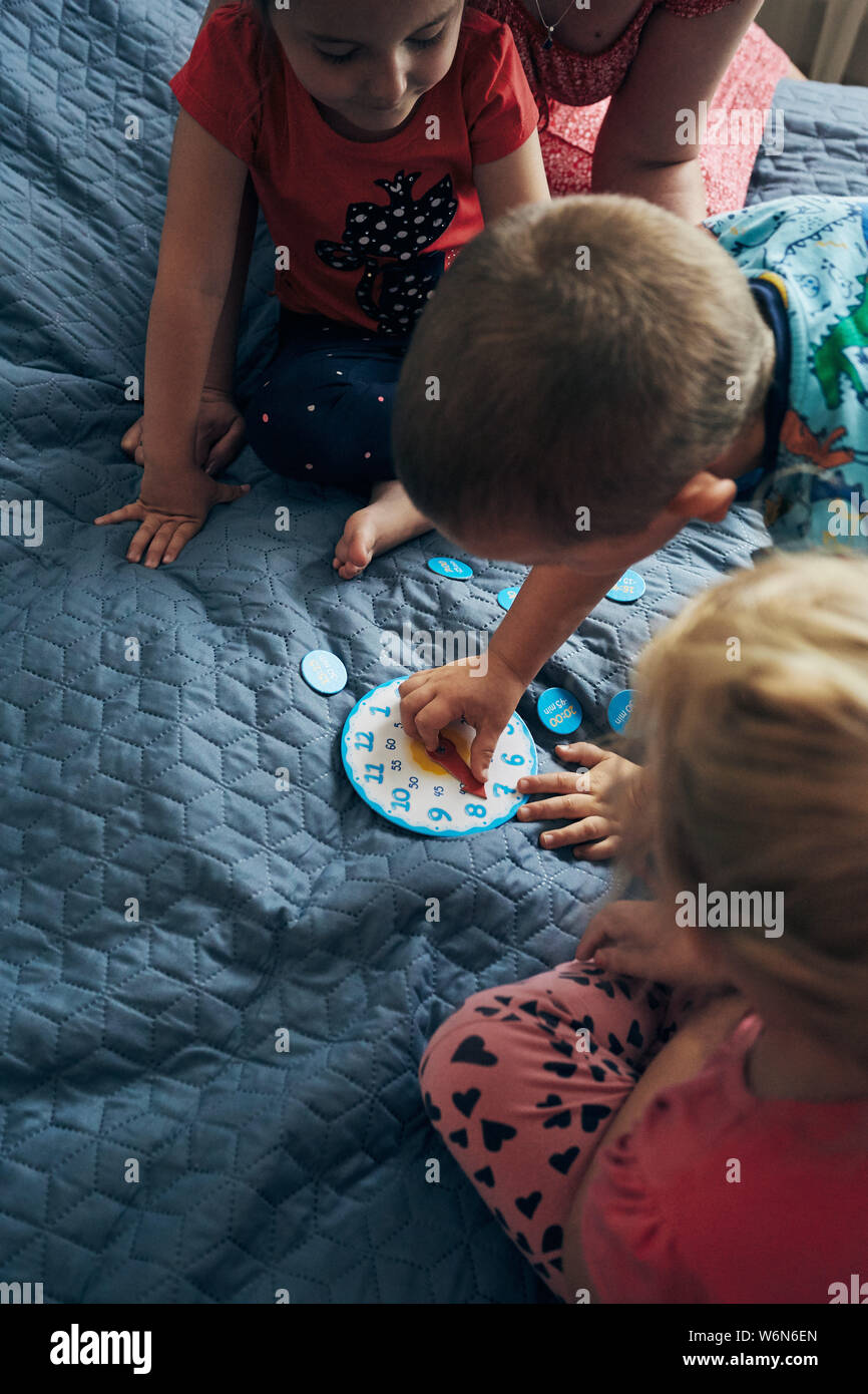 Kids learning how to tell time from clock and set the hands in the ...
