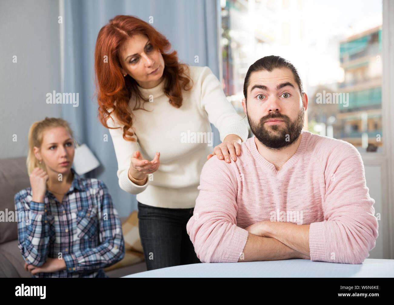 Portrait of woman having serious quarrel with boyfriend of daughter in ...