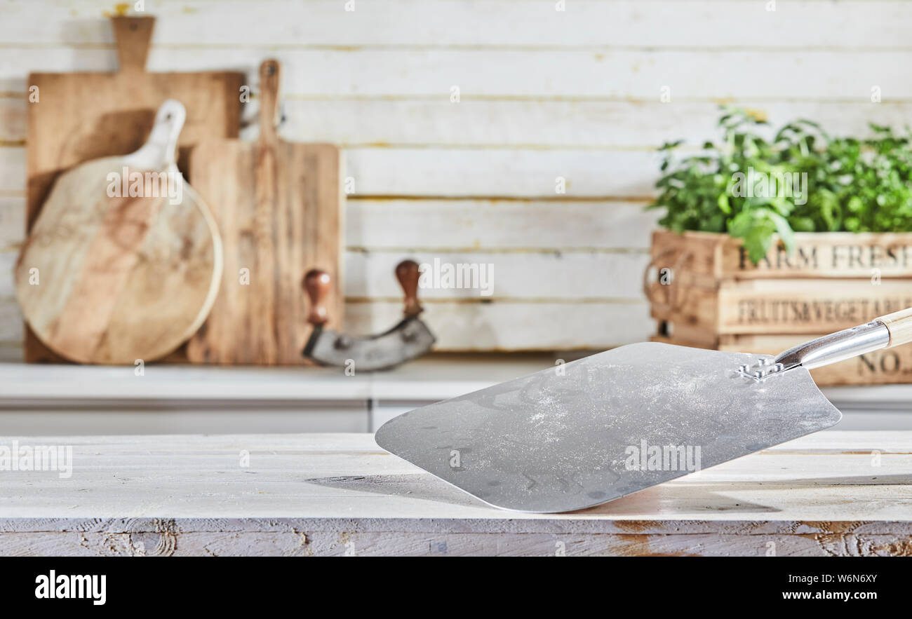 Clean floured metal pizza paddle for flame grilling of Italian cuisine ...