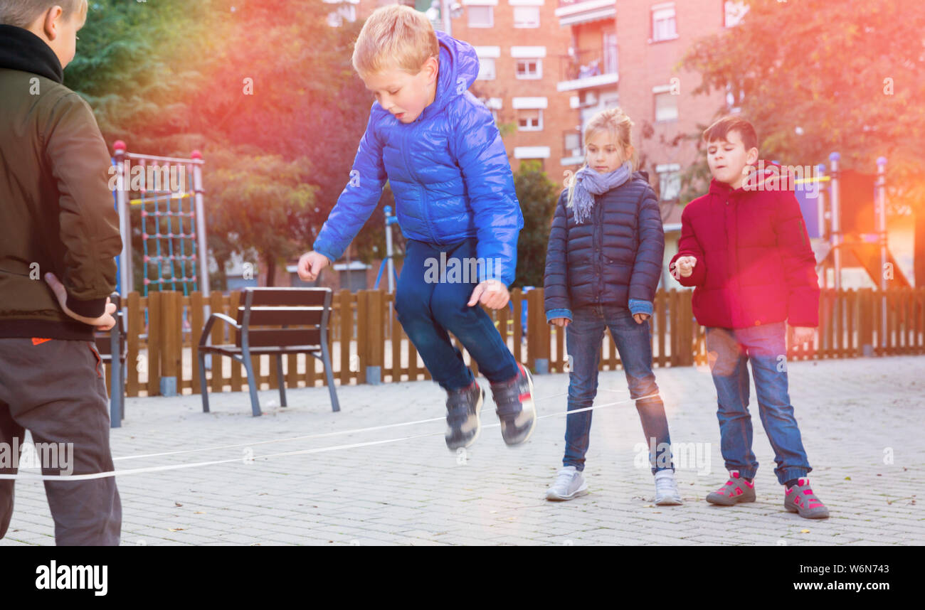 Group of cheerful children having fun together outdoors, playing ...