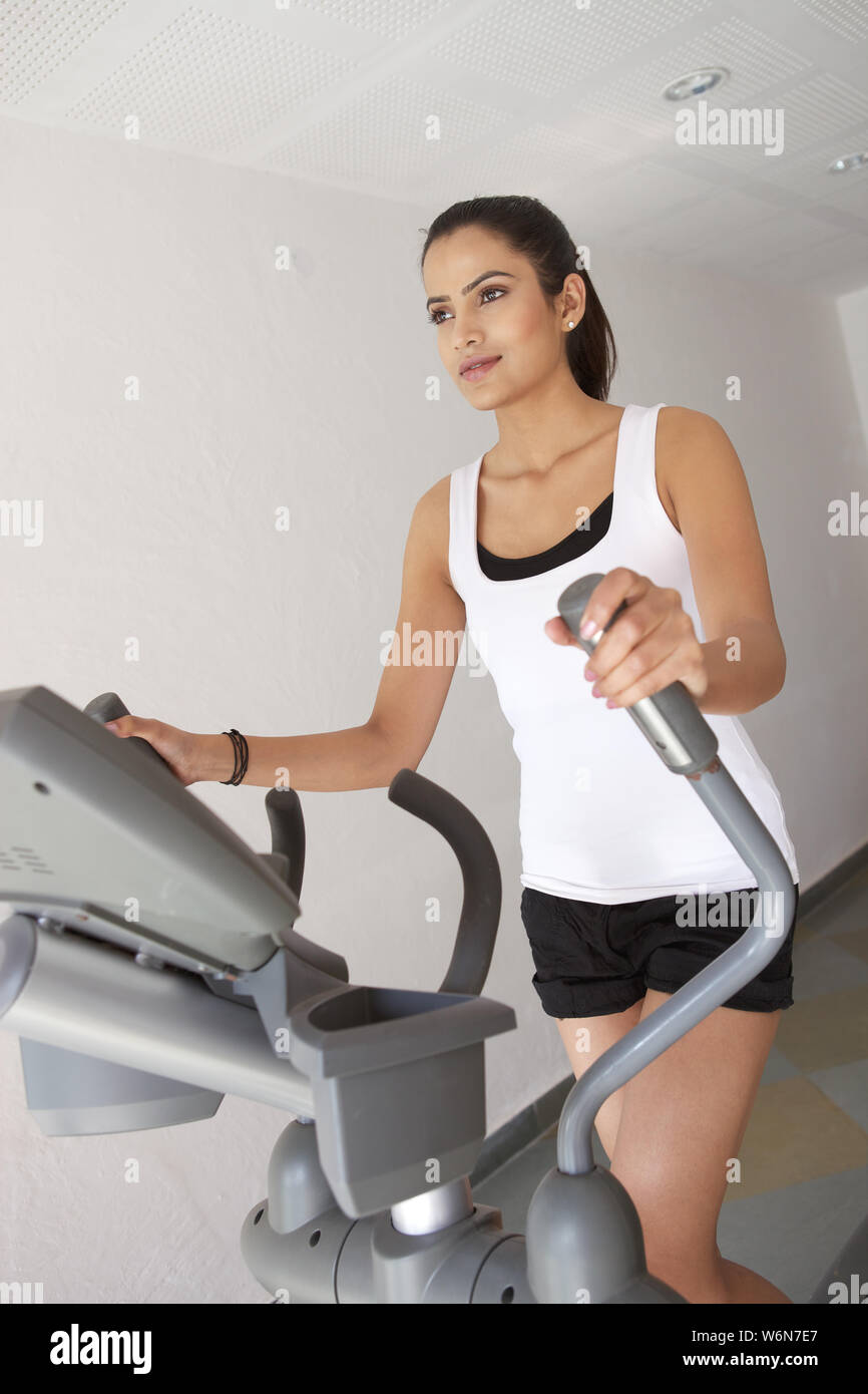 Woman exercising in a gym Stock Photo - Alamy