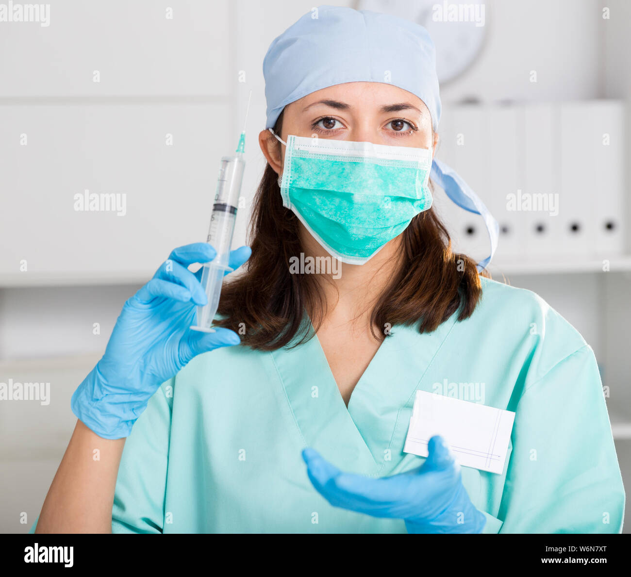 Professional nurse young woman making injection in modern hospital ...