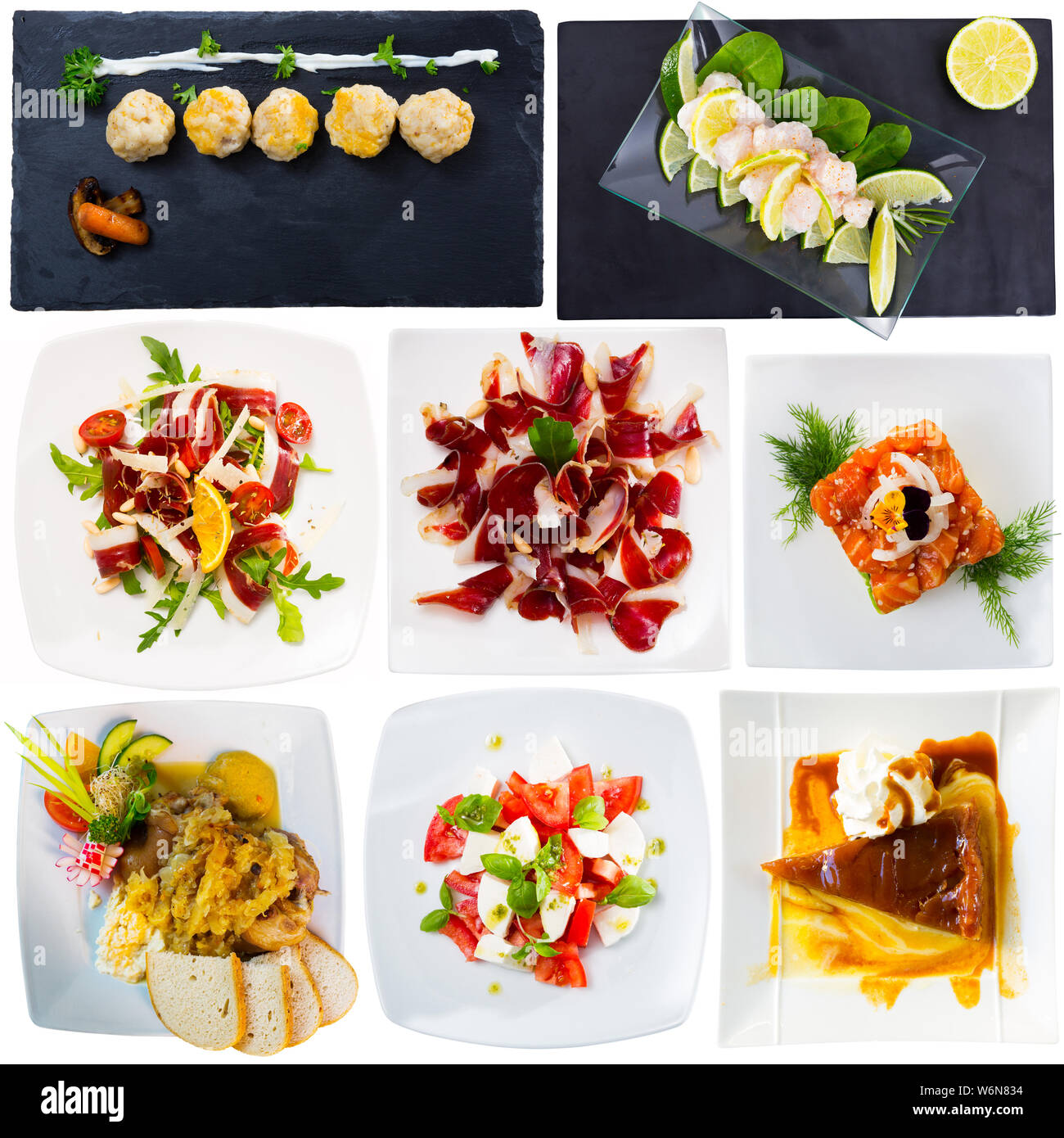 Set of various appetizing dishes served on square plates isolated on ...