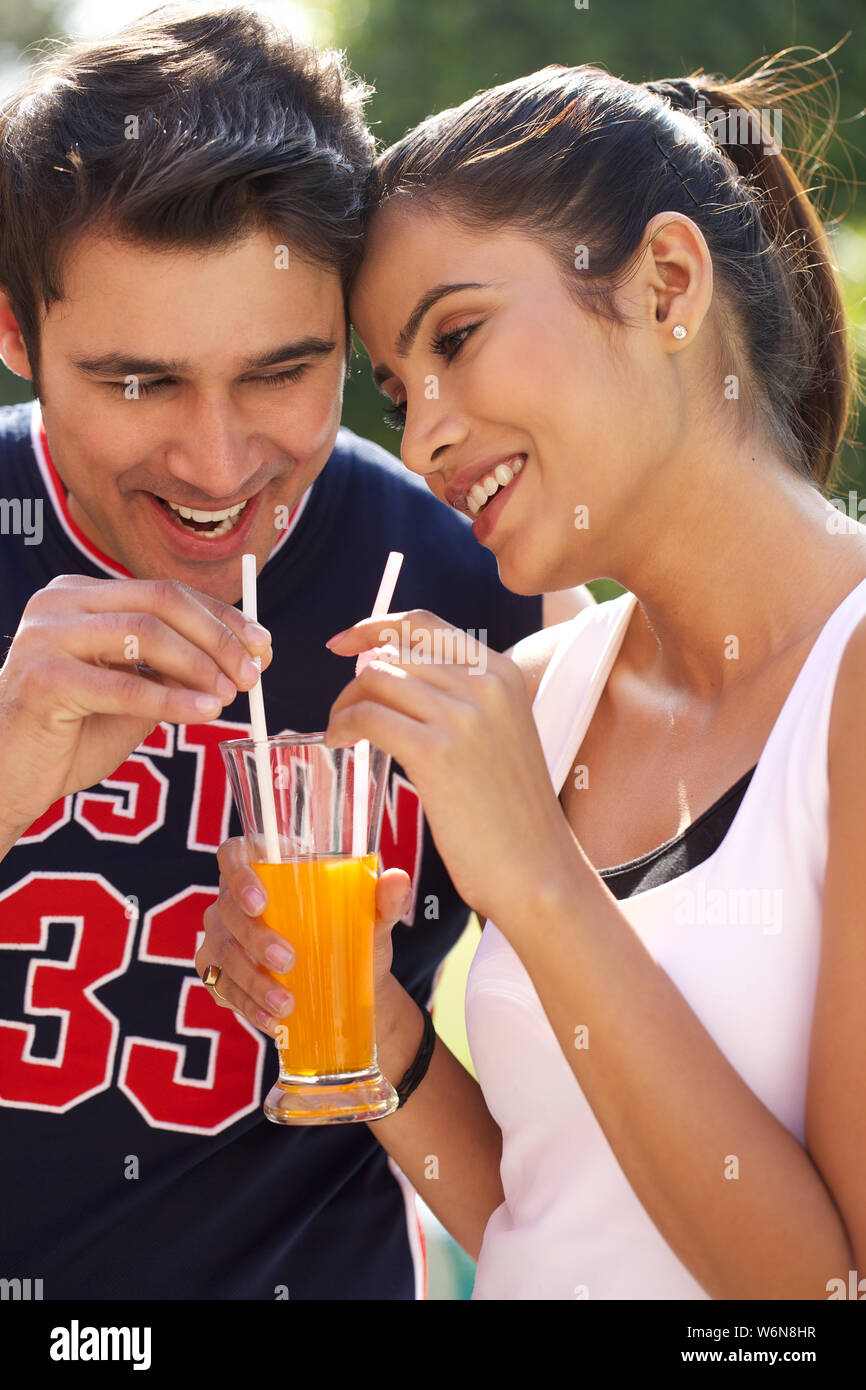 Couple sharing a drink Stock Photo - Alamy