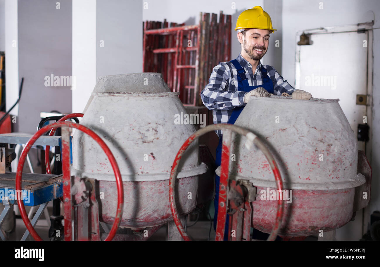 happy spanish working man practicing his skills with mixing unit at ...