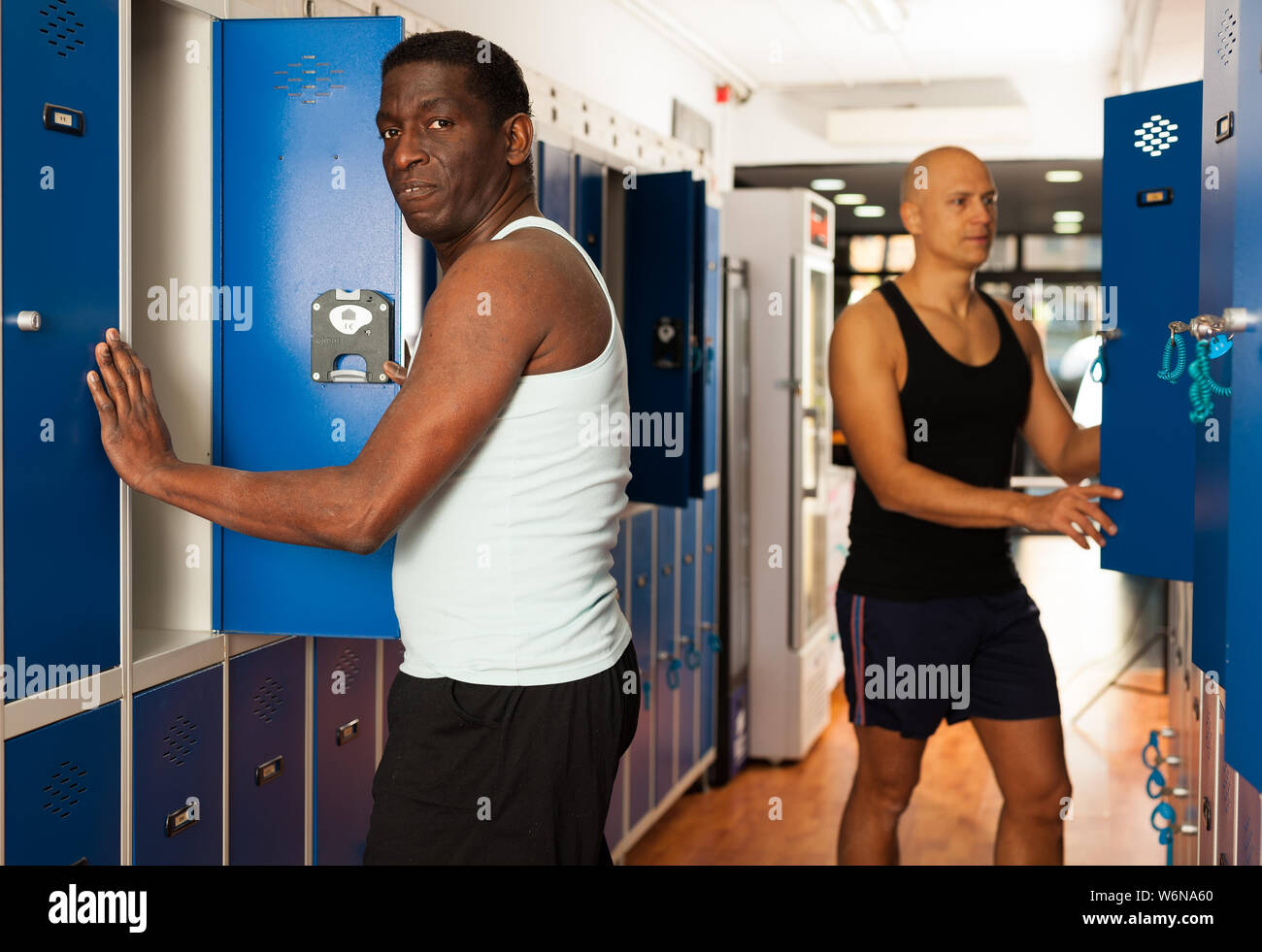Two athletes in the locker room after training Stock Photo - Alamy