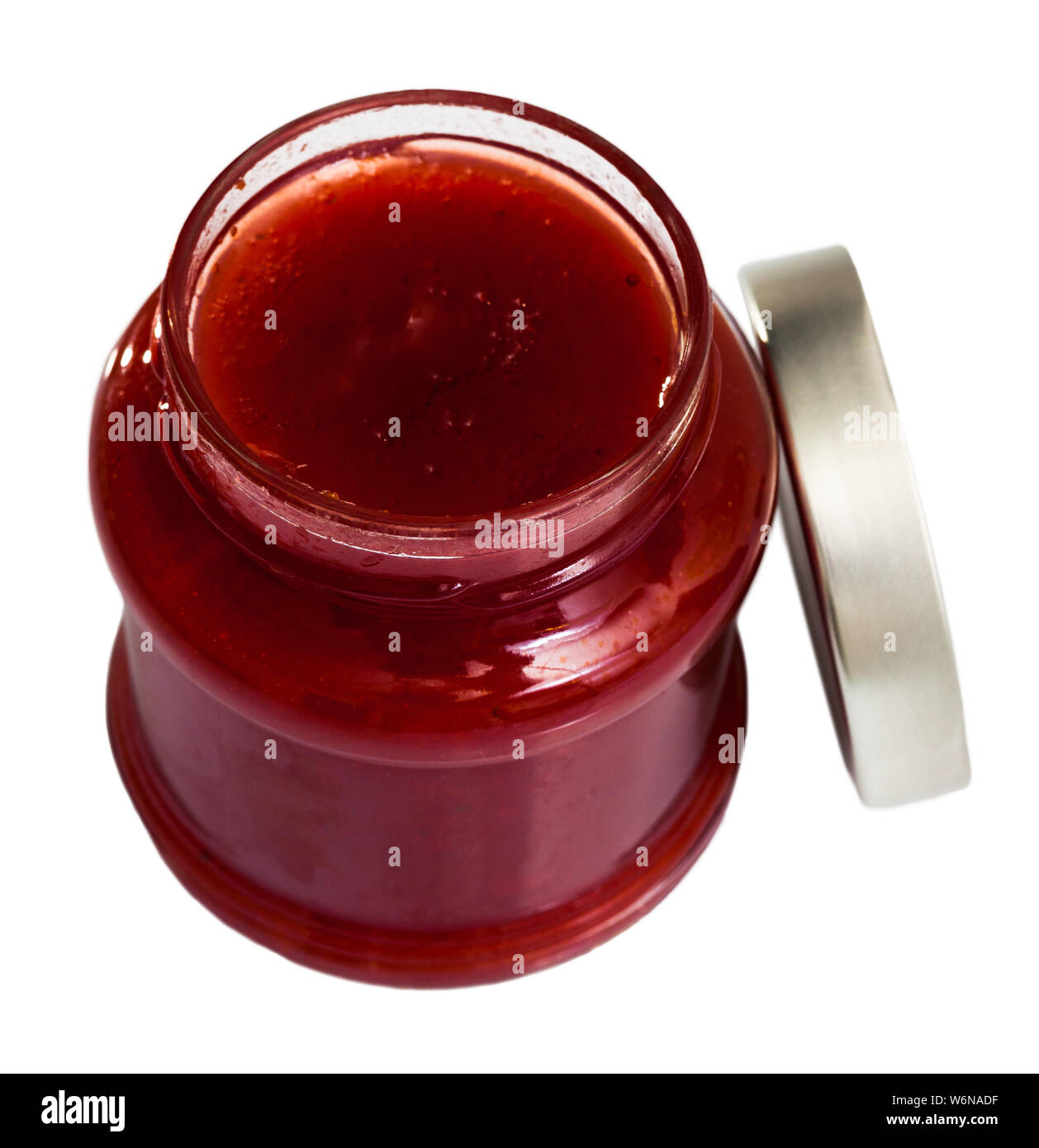 Glass jar of strawberry jam, closeup. Isolated over white background ...
