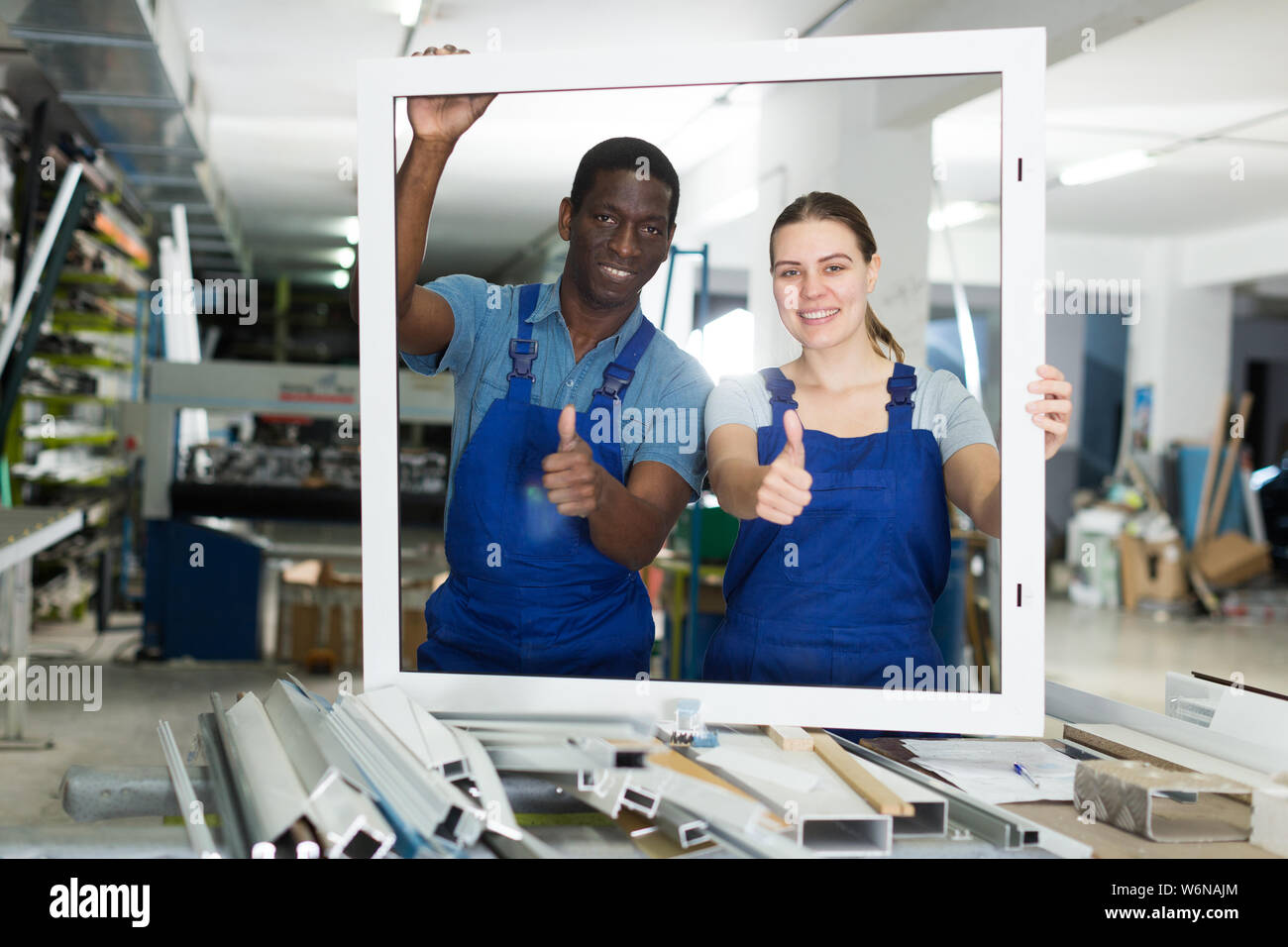 Two masters are working with window frame in the window workshop Stock ...