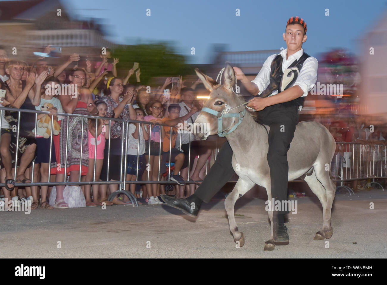 Tribunj, Croatia. 01st Aug, 2019. A man rides a donkey during the 52nd ...
