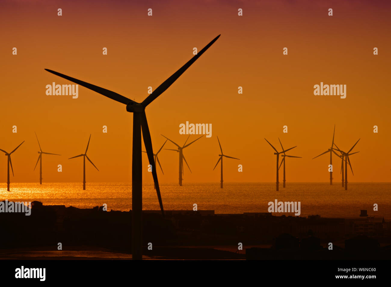 Burbo Bank Offshore Wind Farm turbines Liverpool Bay in silhouette ...