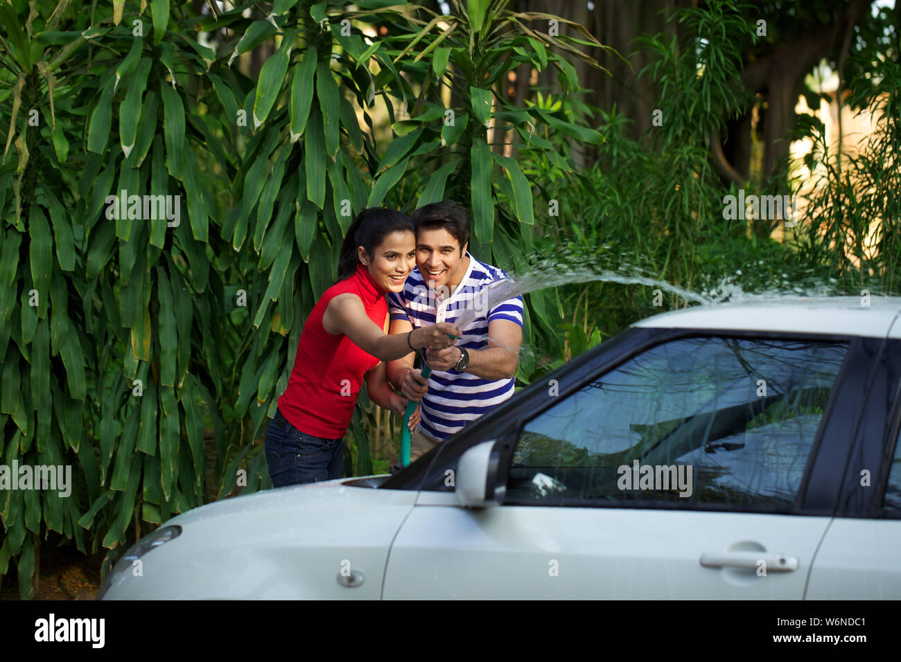 Young couple washing car together Stock Photo - Alamy