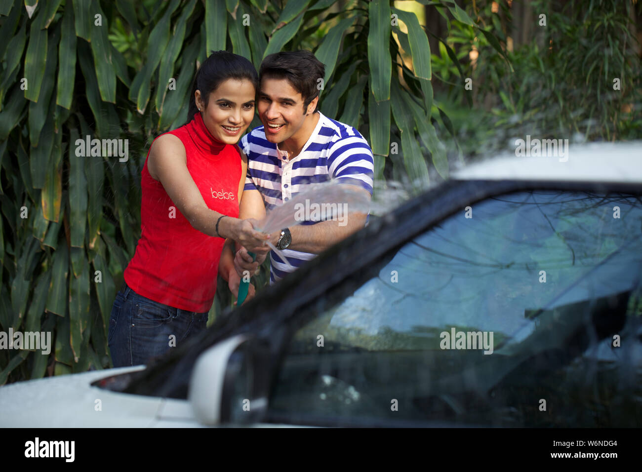 Young couple washing car together Stock Photo - Alamy