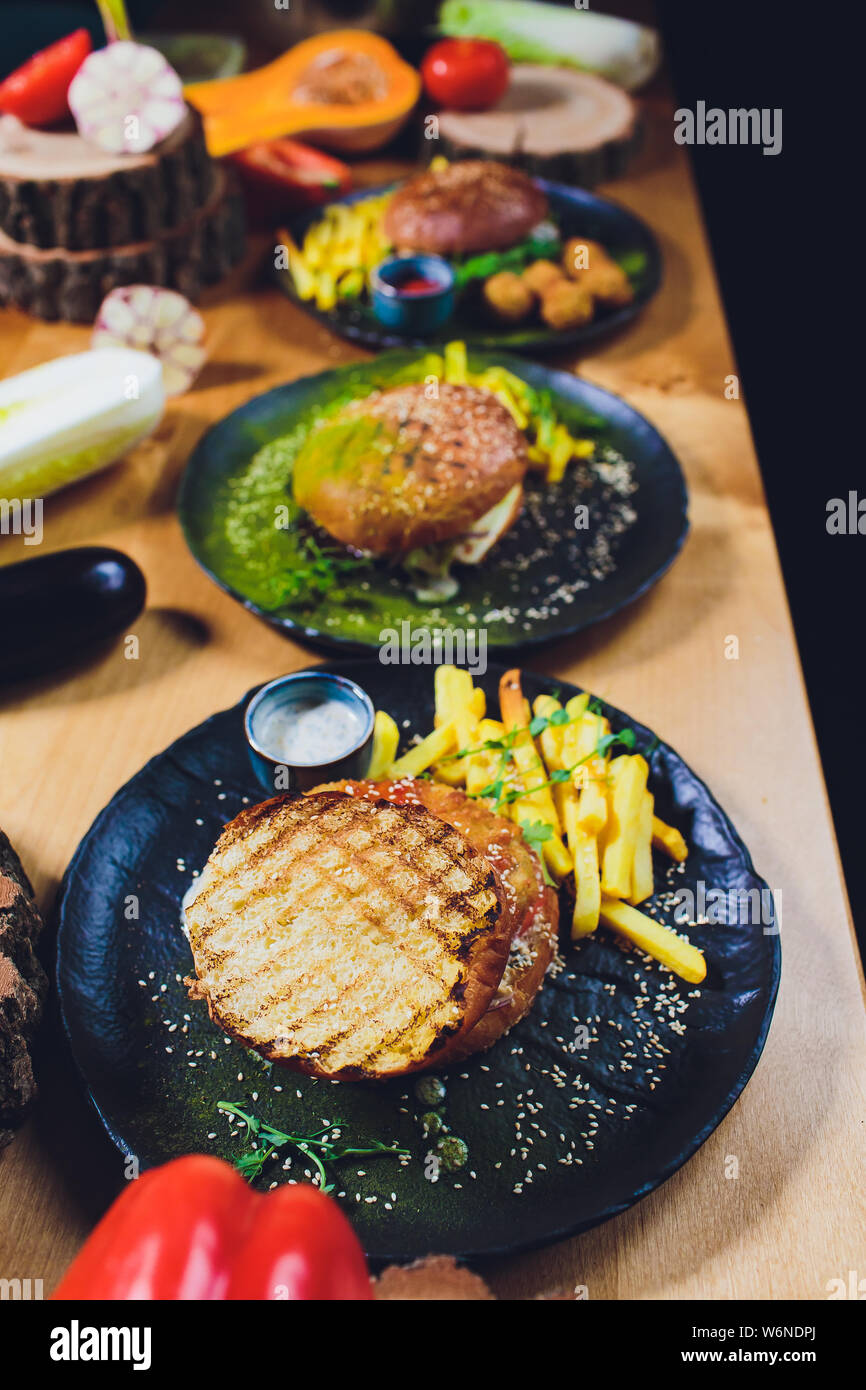 Red, green,black mini burgers with quinoa and vegetables Stock Photo ...