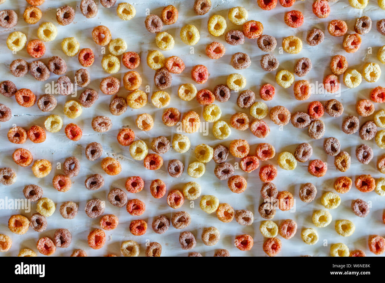 Colorful breakfast fruit loops on white background Stock Photo - Alamy