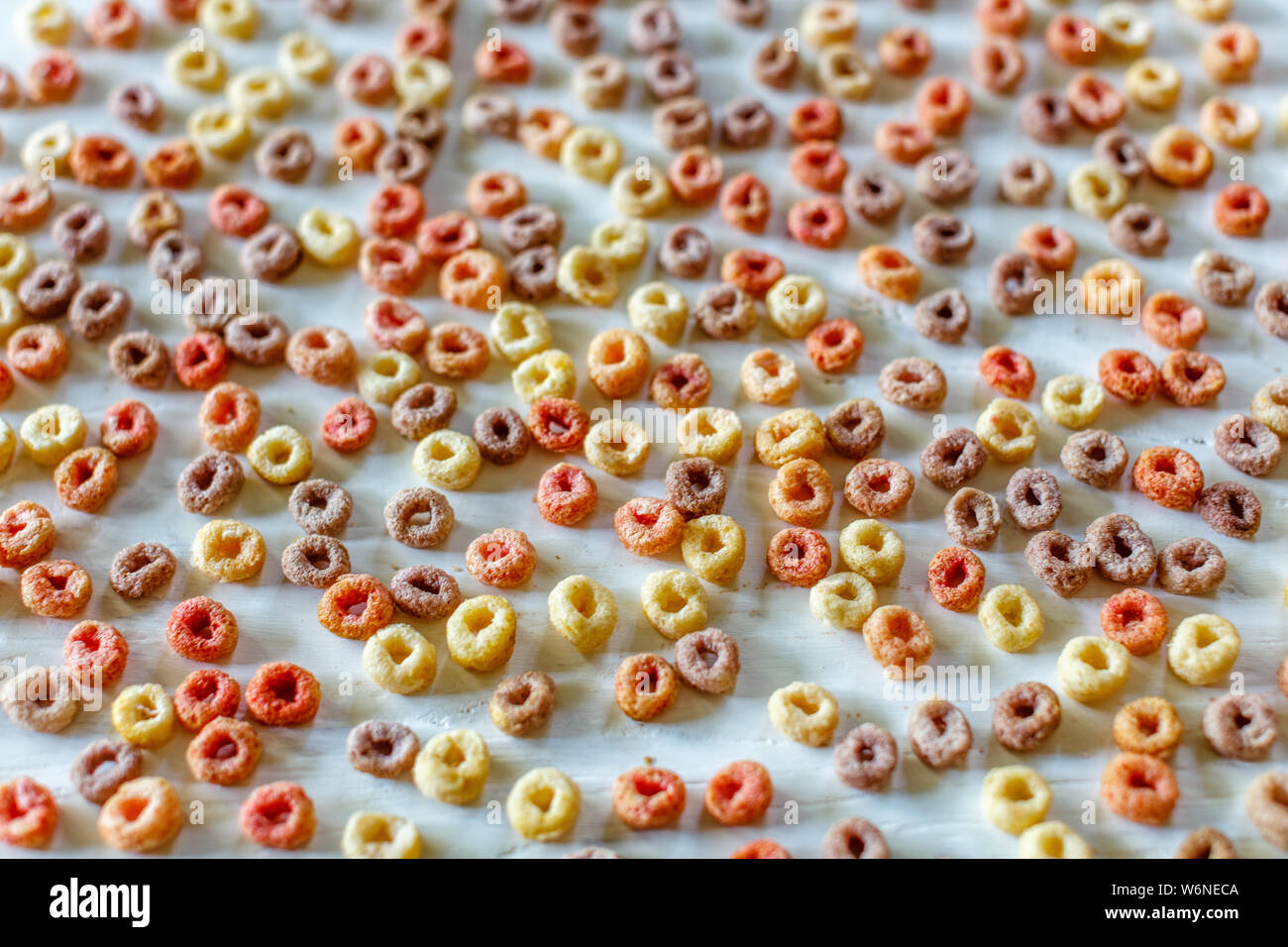 Colorful breakfast fruit loops on white background Stock Photo - Alamy