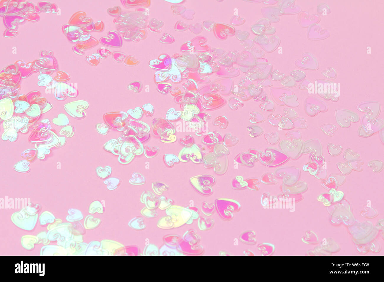 Heart holographic confetti sparkles on pink background. Trendy flat lay ...