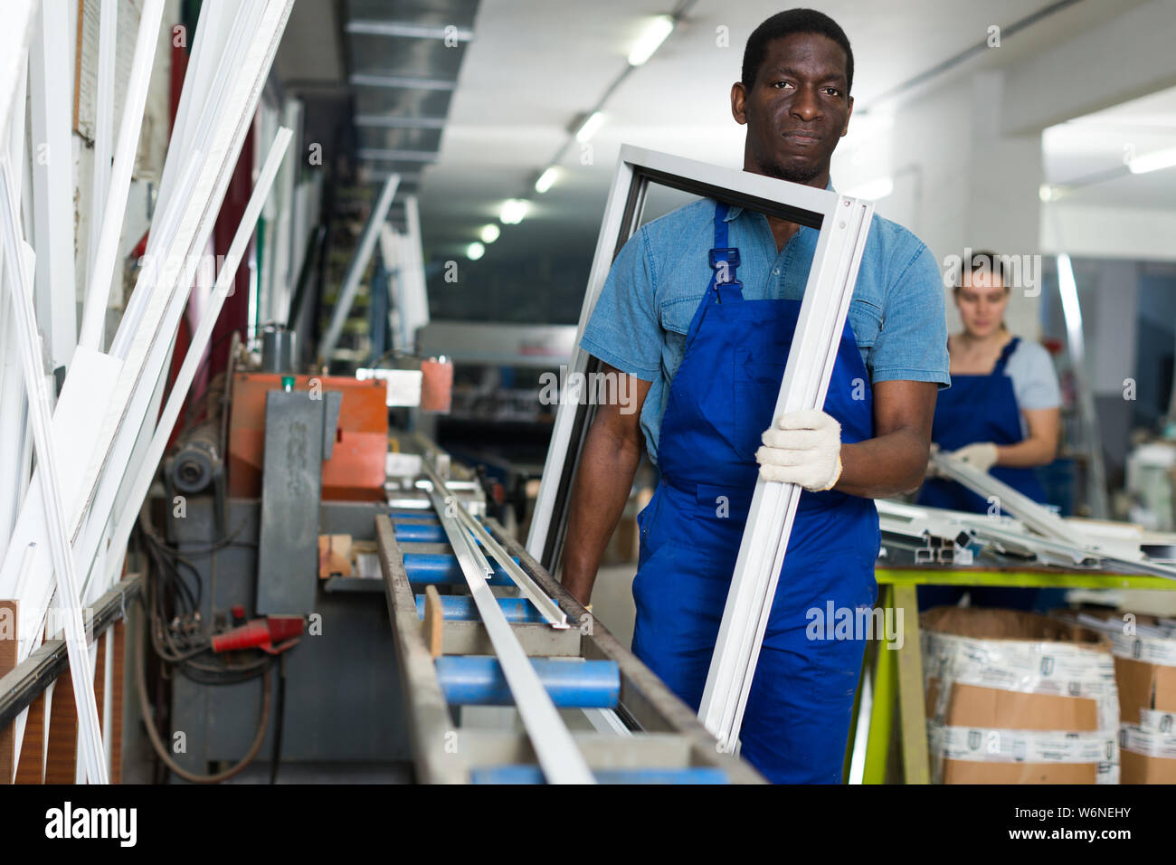 Male master is working with window frame in the window workshop Stock ...